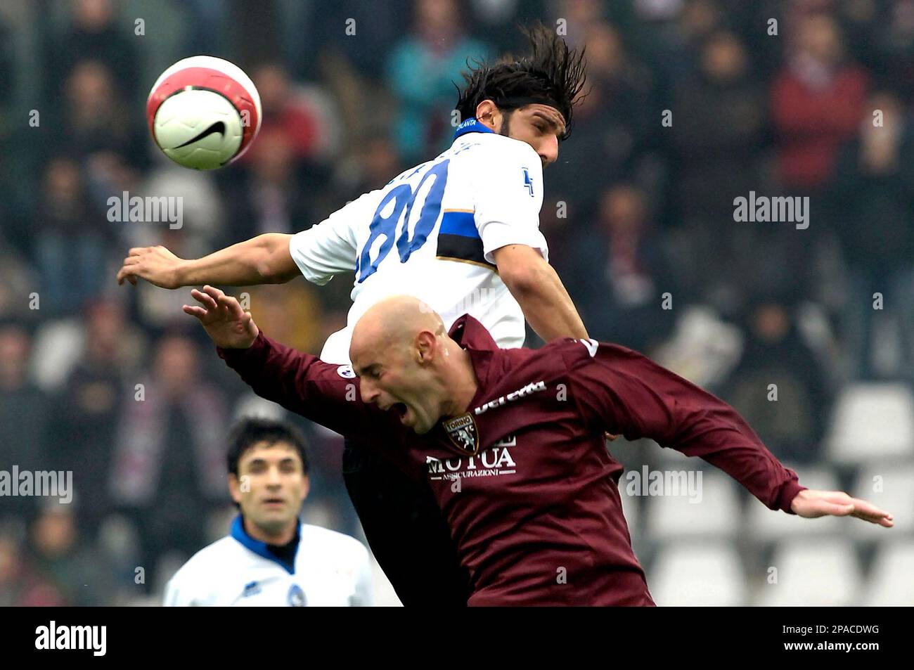 Torino's Roberto Stellone, at bottom, is out jumped by Atalanta's Moris ...