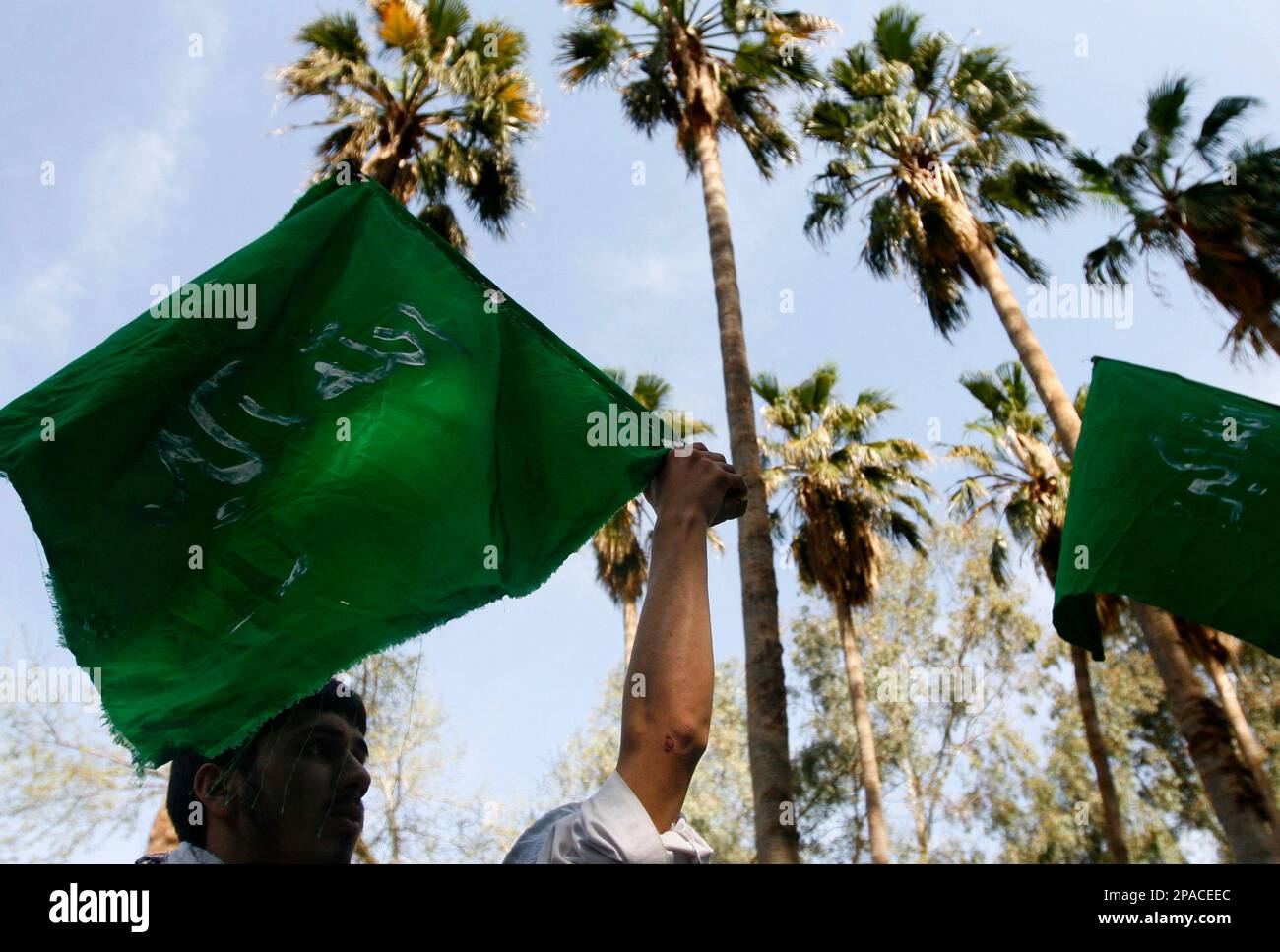 Afghan student carry flags which read, "Allah is Great," during a ...