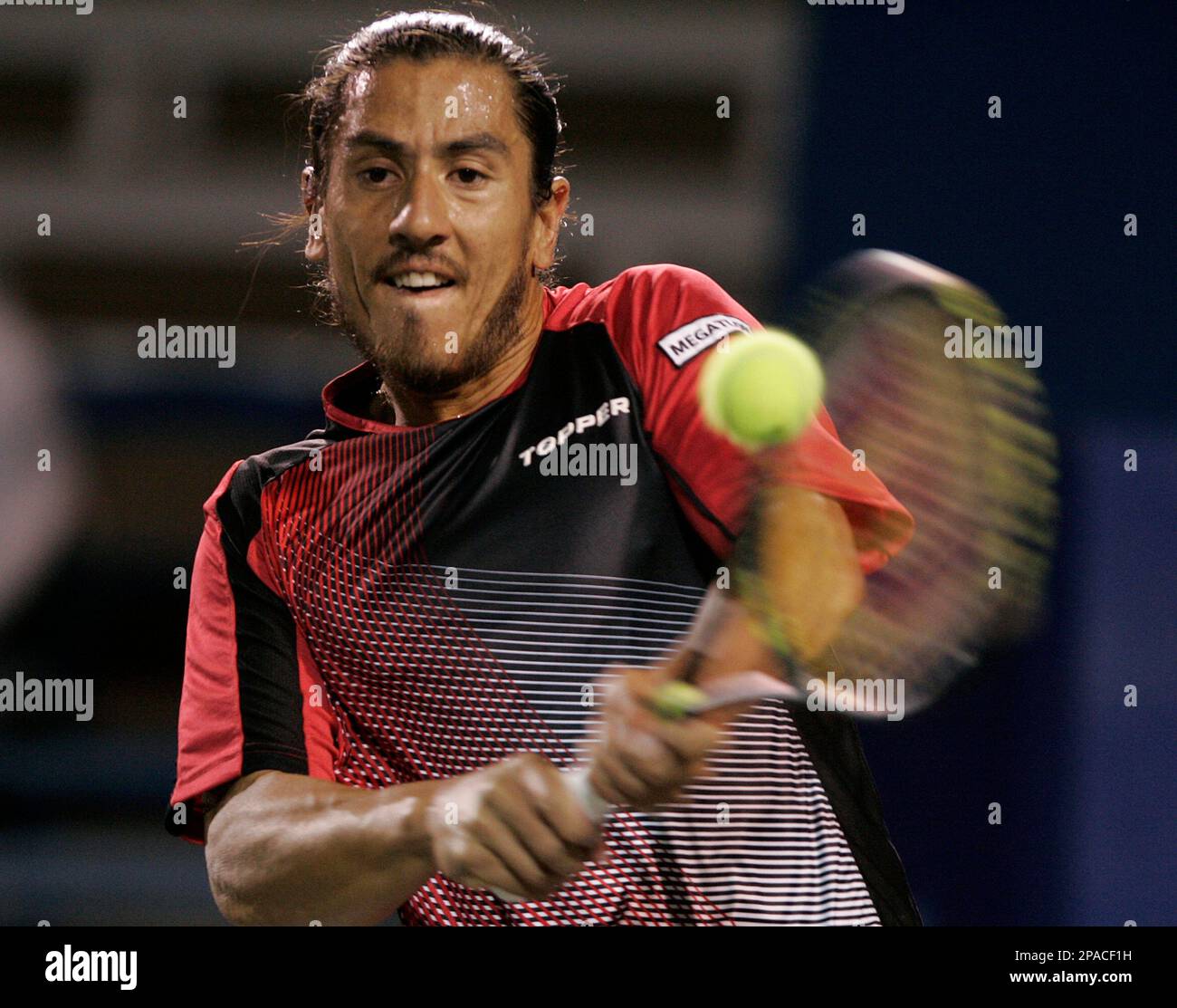 Guillermo Canas, of Argentina, returns the ball to Sam Querrey during a ...