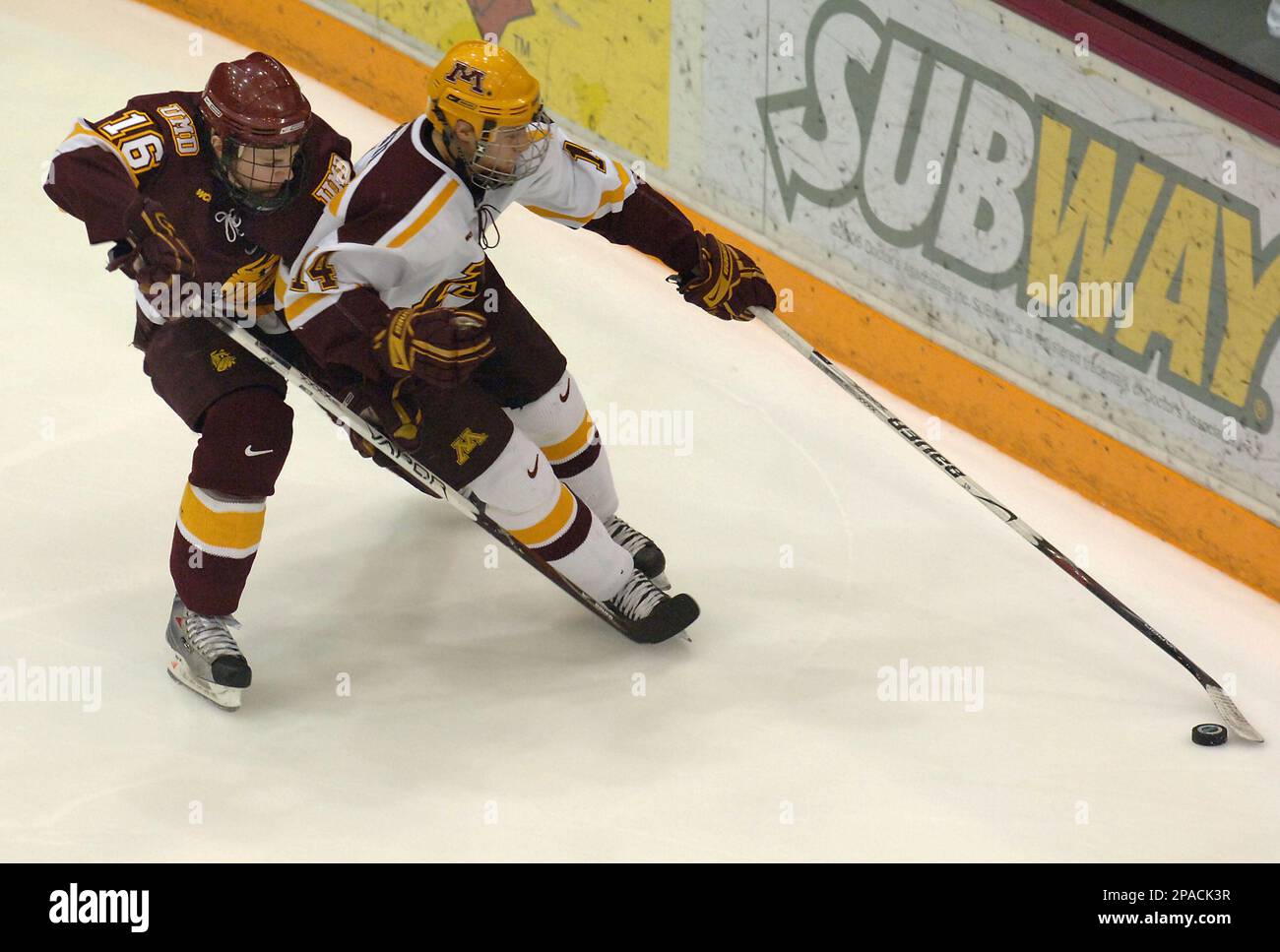 Minnesota-Duluth's Matt Greer, left, and Minnesota's Justin Bostrom vie ...