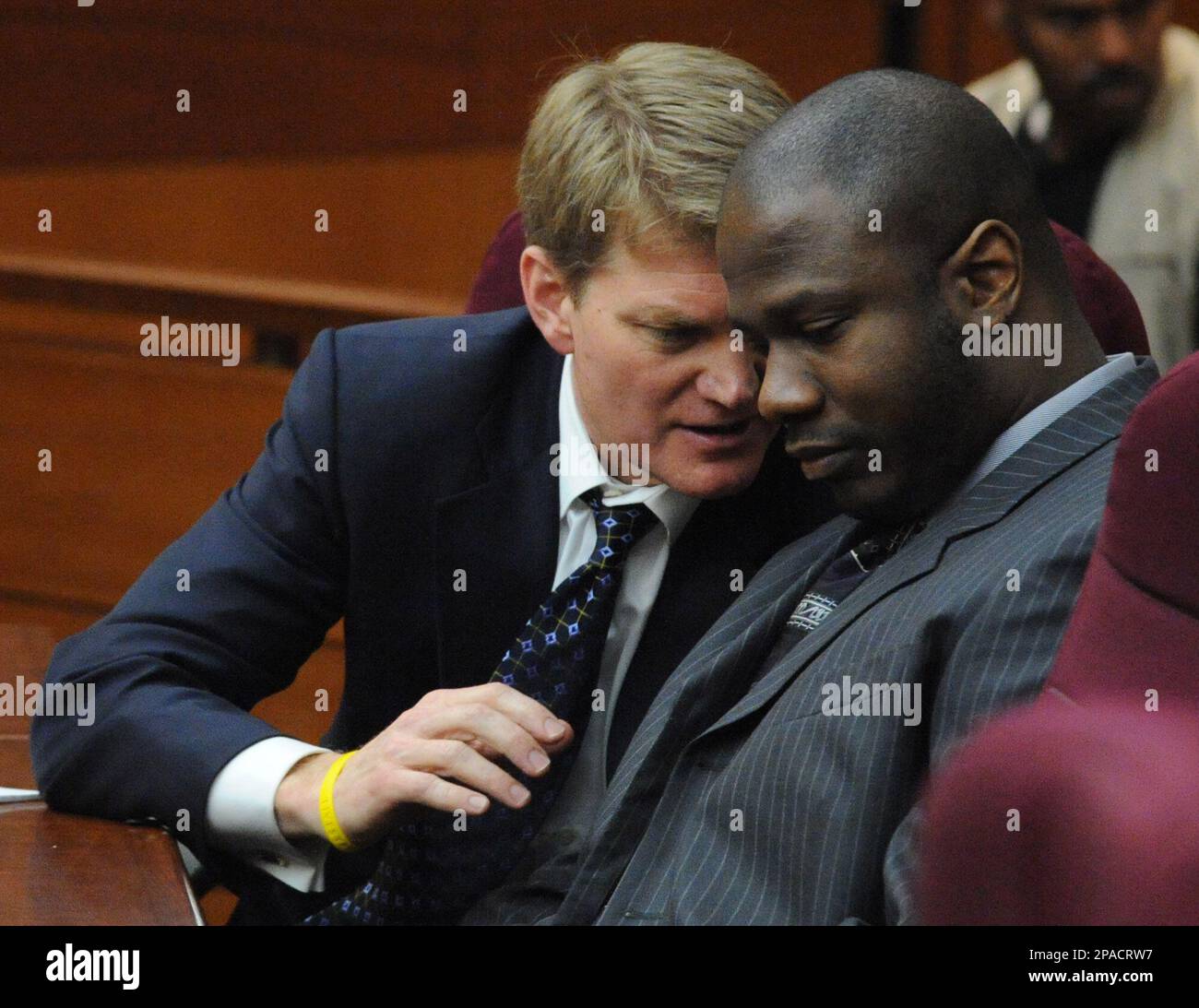 Defense attorney Robert McGlasson, left, talks with his client Brian ...