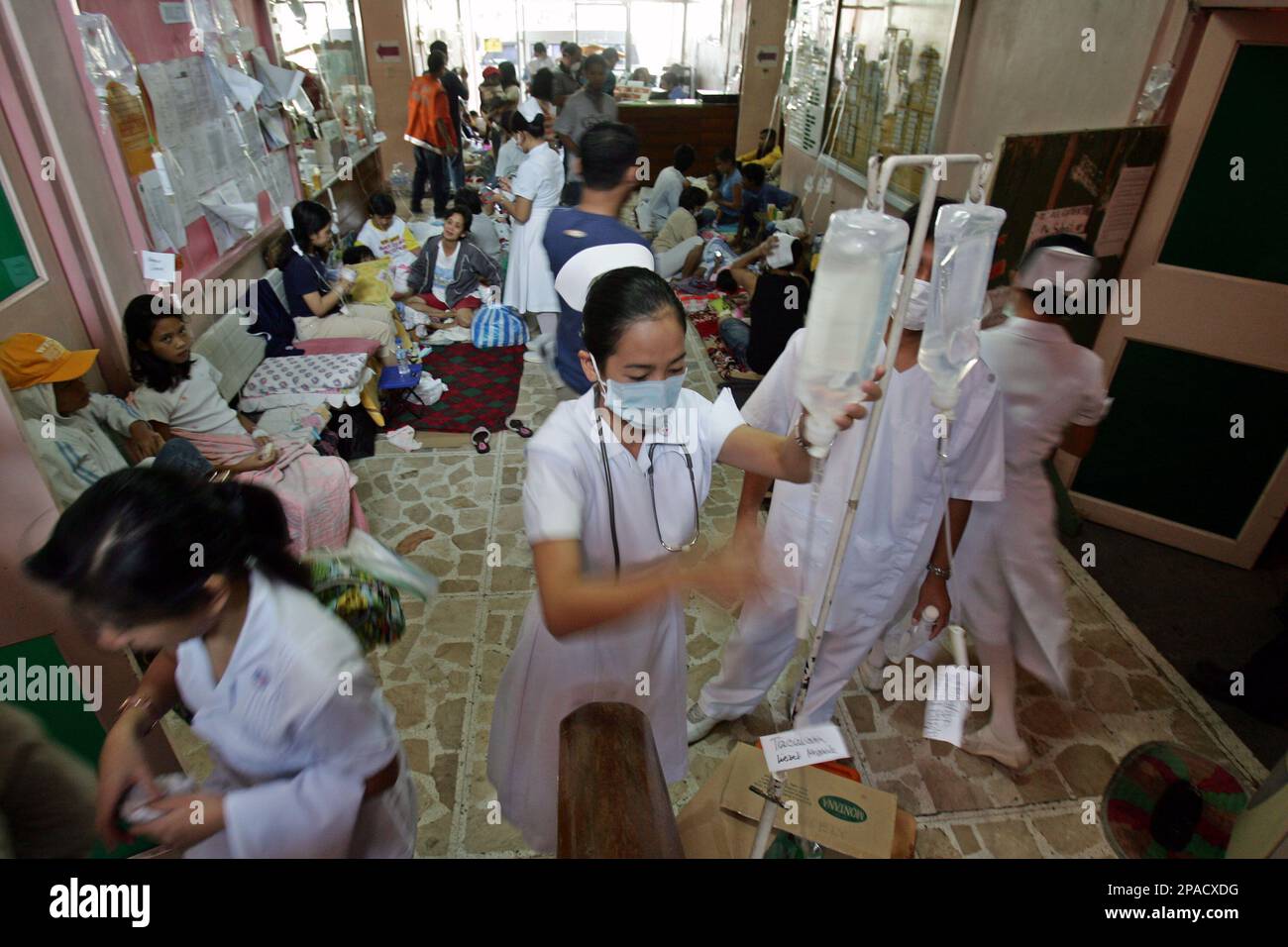 Filipino doctors and nurses tend to patients along the corridors of the ...