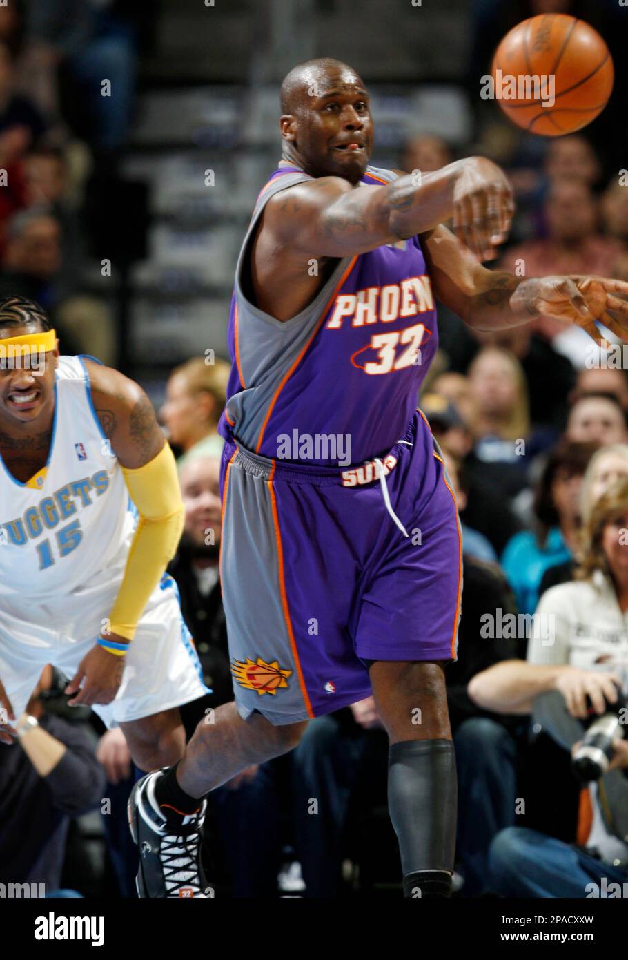 Phoenix Suns center Shaquille O'Neal passes the ball after pulling in a ...