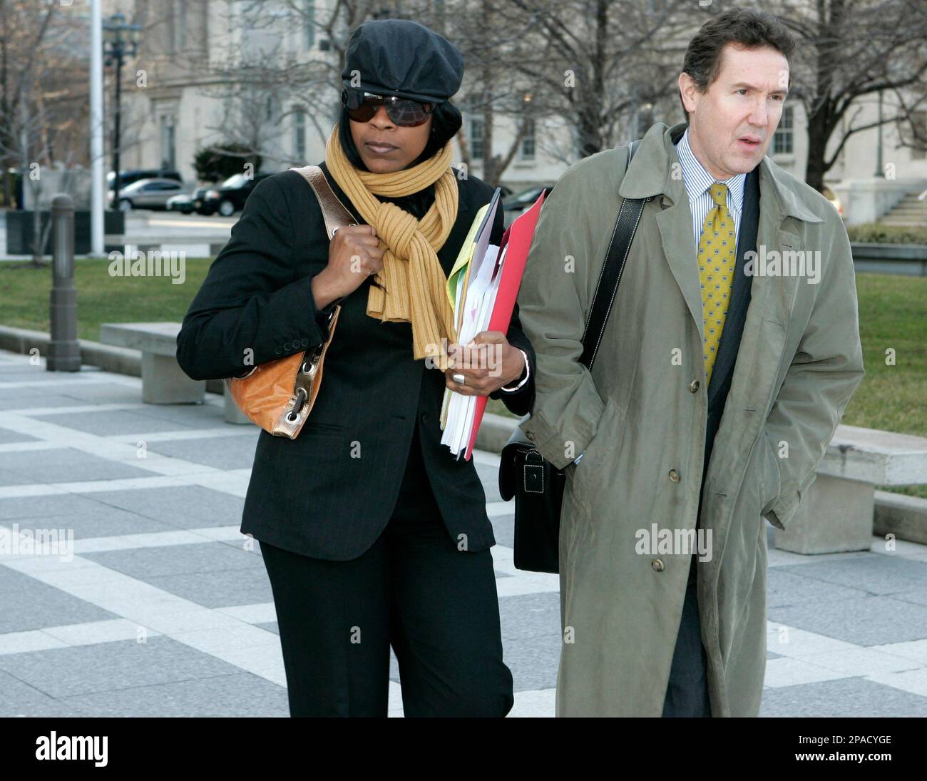Tamika Riley, left, leaves the U.S. District Courthouse in Newark, N.J ...