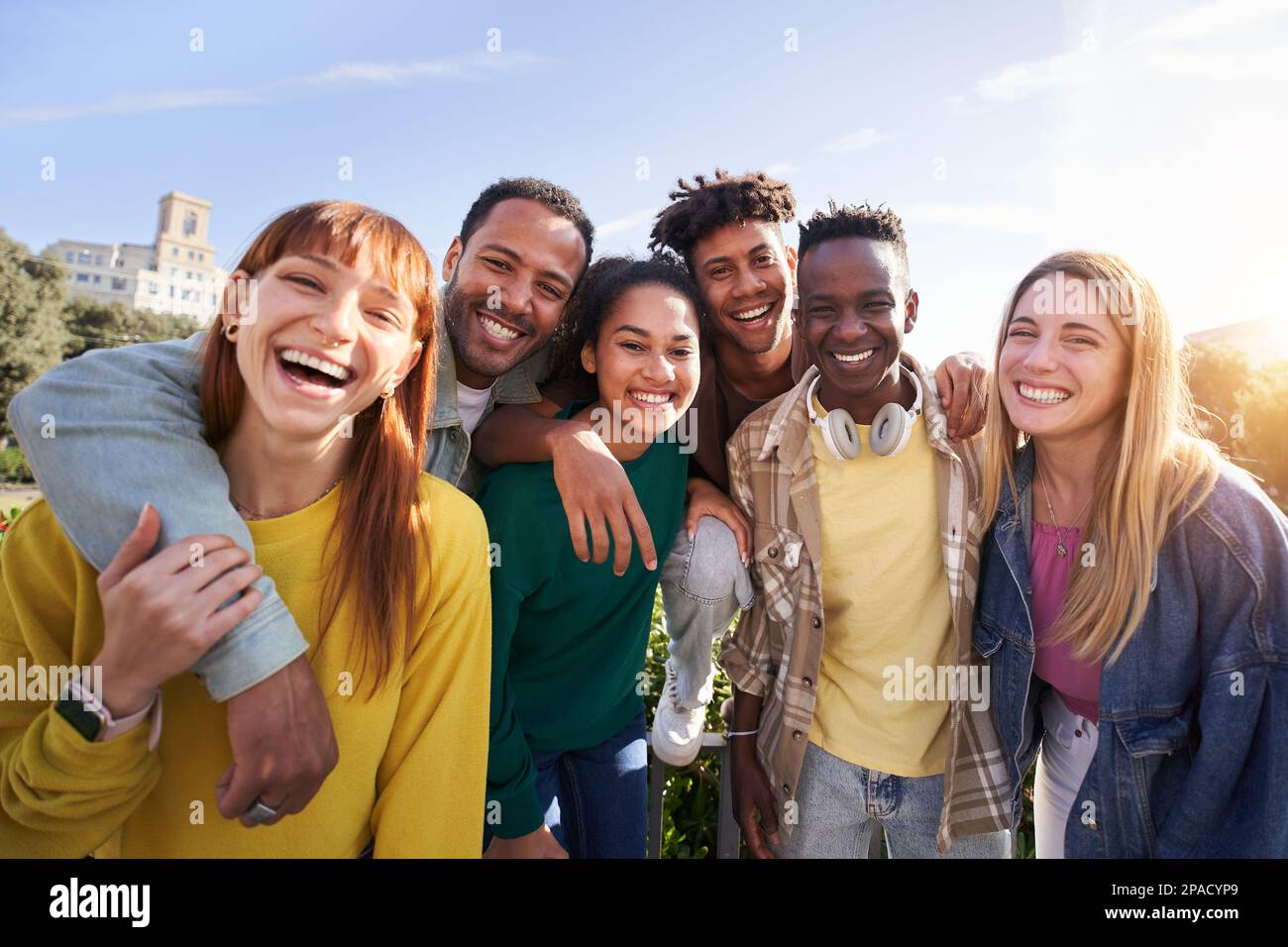 Young smiling happy looking at camera hugging. Group of multicultural ...
