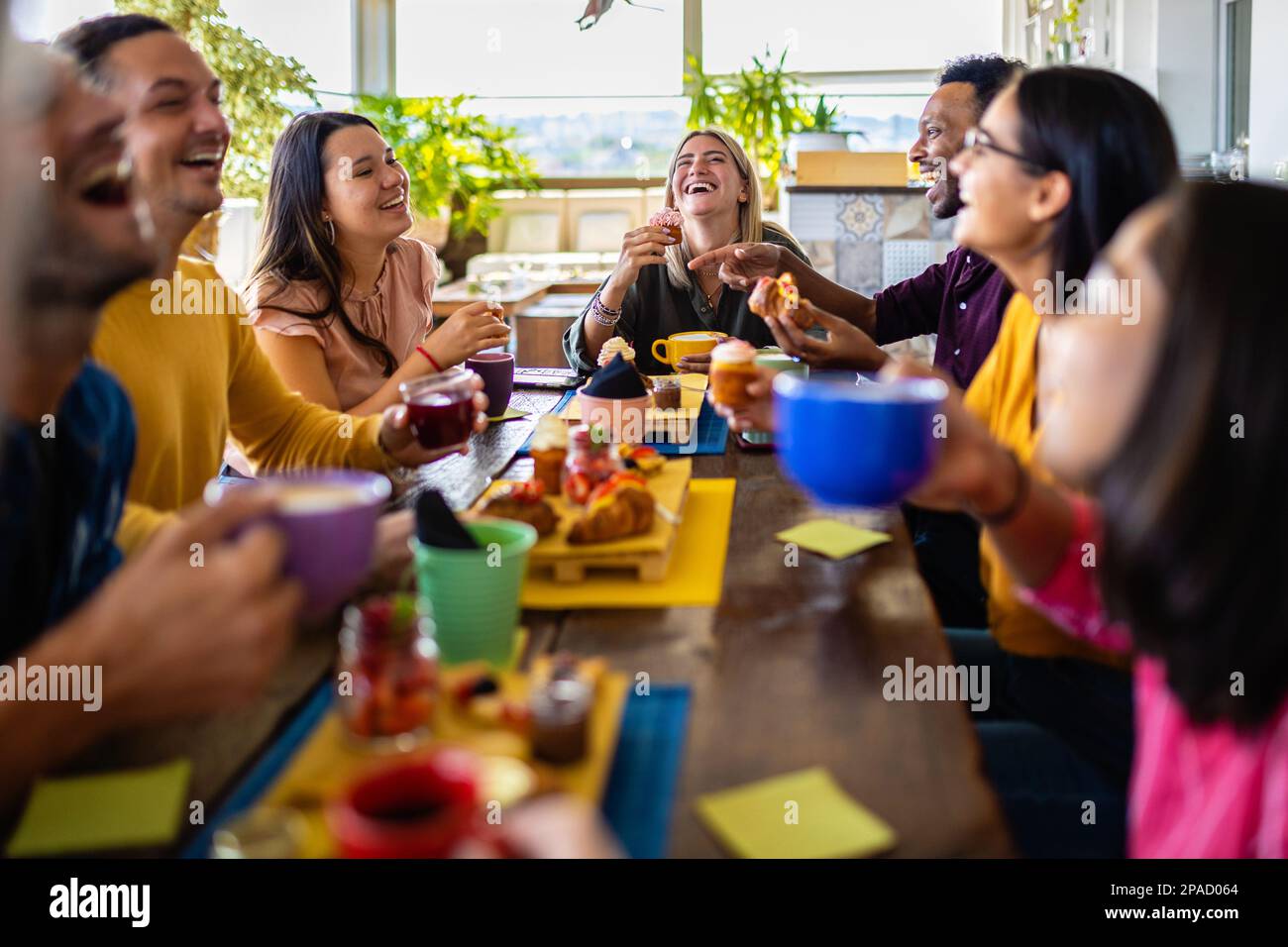Happy young group of diverse friends having fun talking at coffee ...