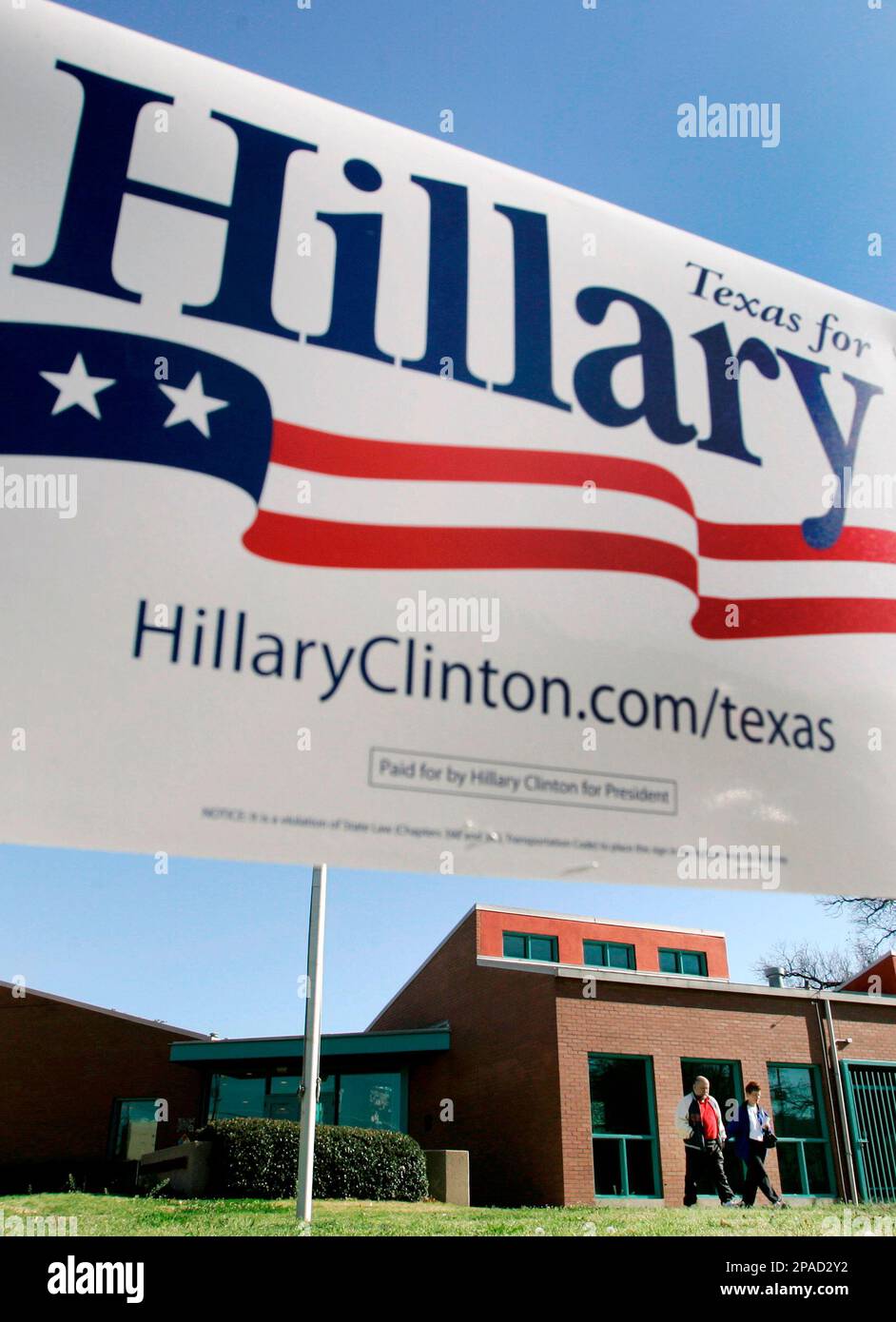 A campaign sign is shown as Benny Barrett, bottom left, and his wife ...
