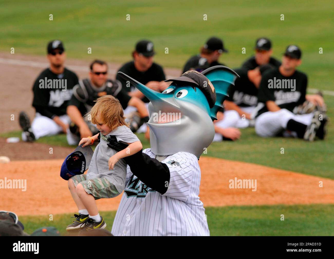 Florida Marlins mascot Billy the Marlin, holds up three-year-old Bryson ...