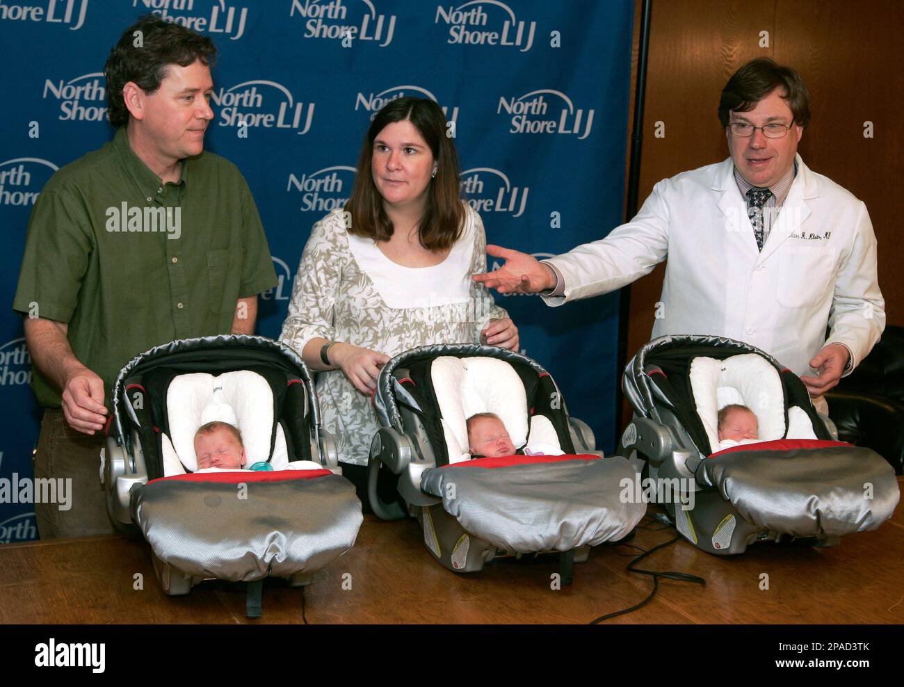 Tom and Allison Penn stand with their identical triplets, Logan, Eli ...