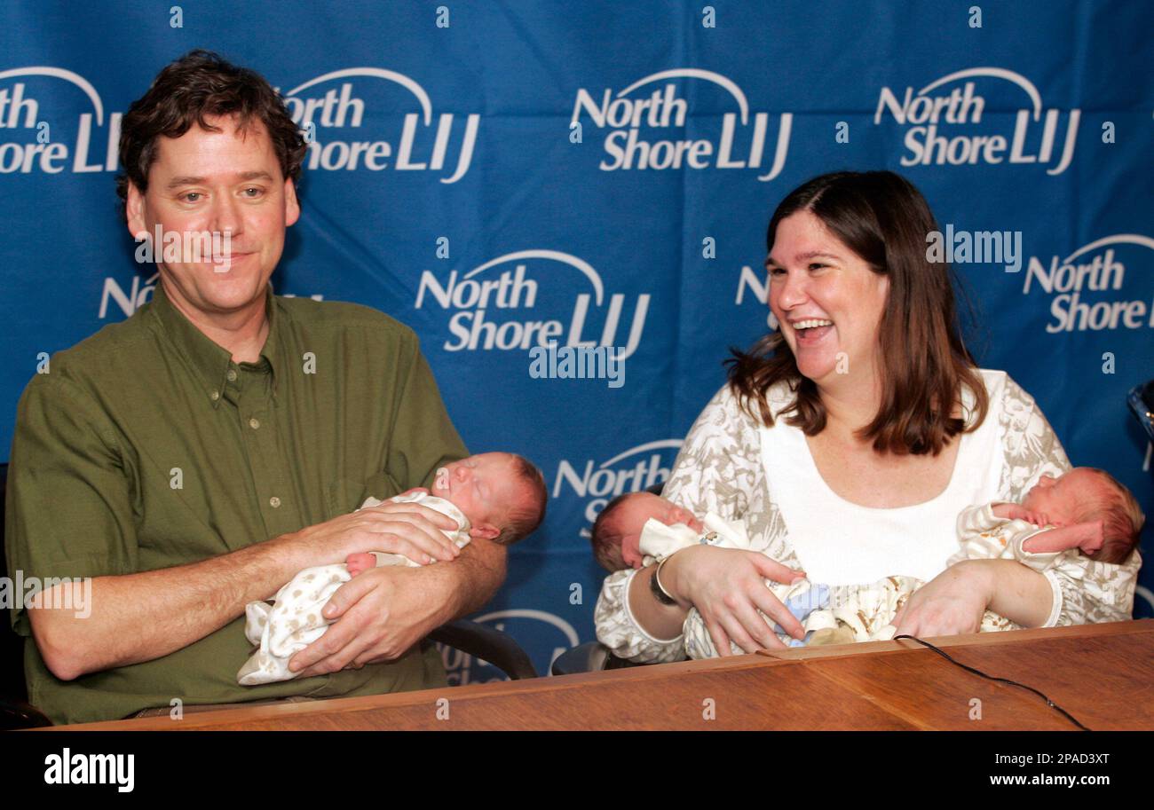 Allison and Tom Penn hold their identical triplets, from left, Logan ...