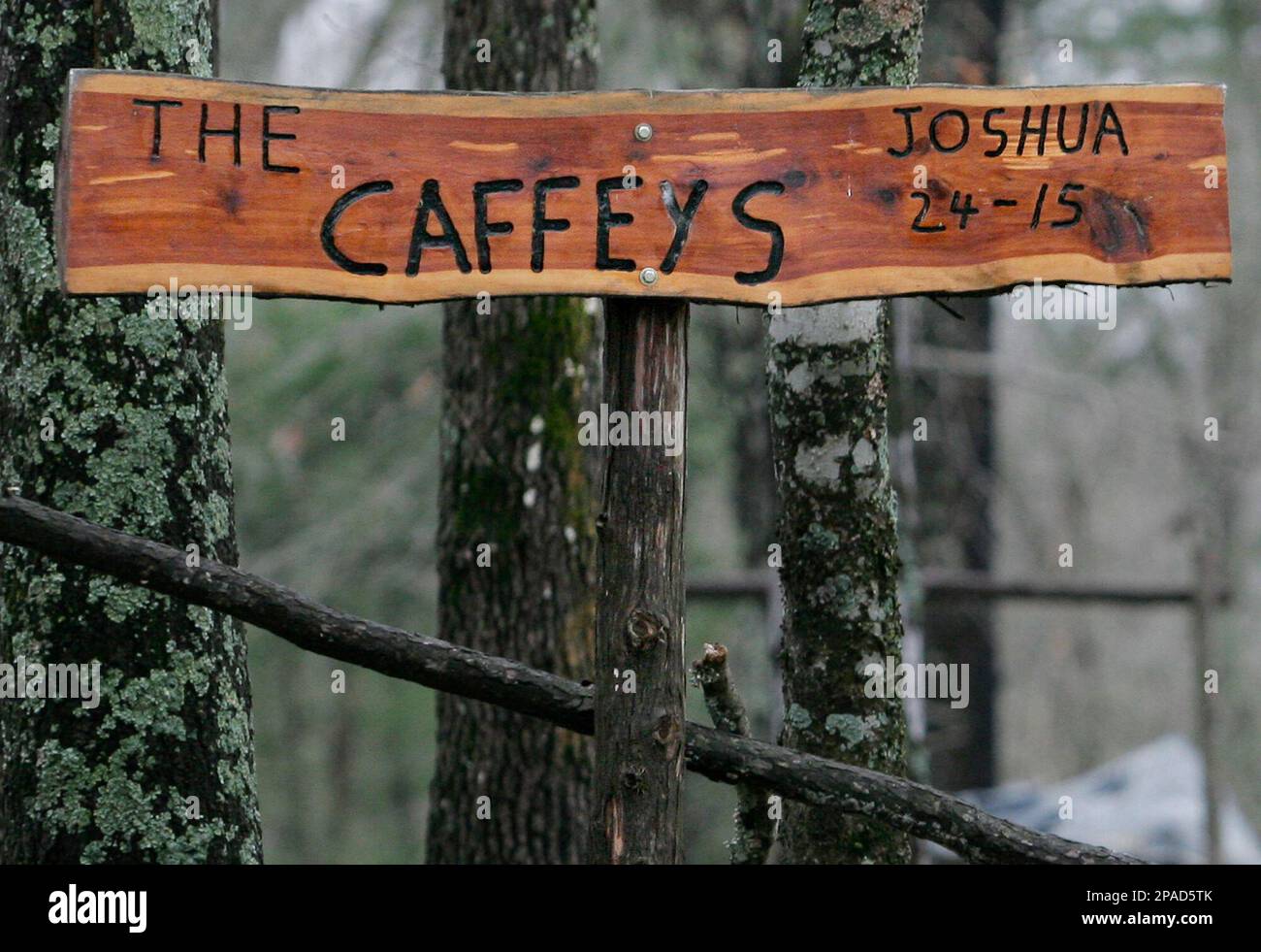 A homemade sign at the Caffey residence references a verse in the Bible ...