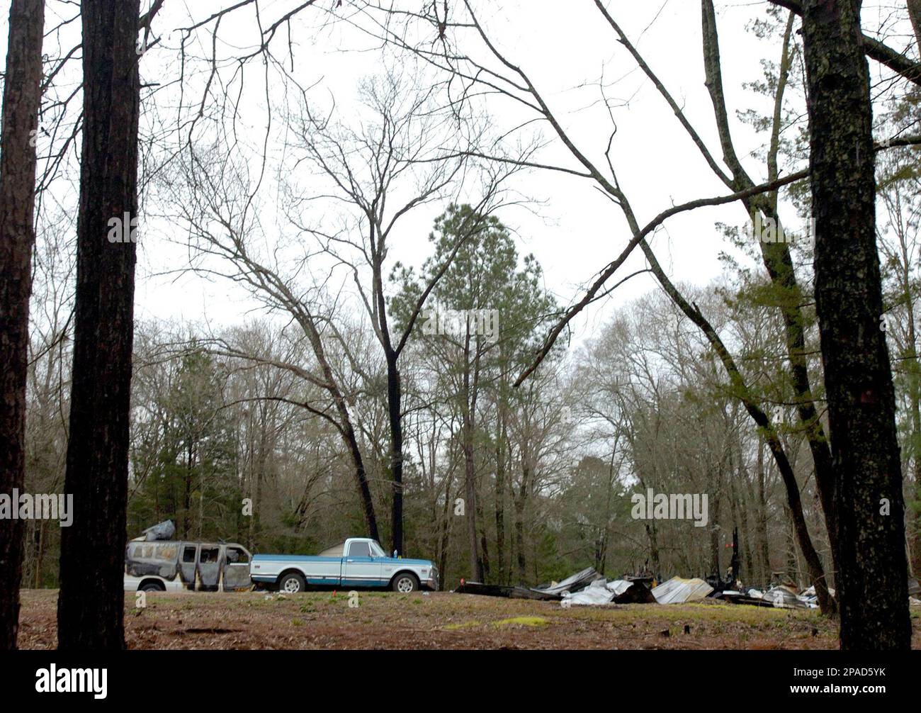 The burned remains of the Caffey residence and a vehicle are seen on ...