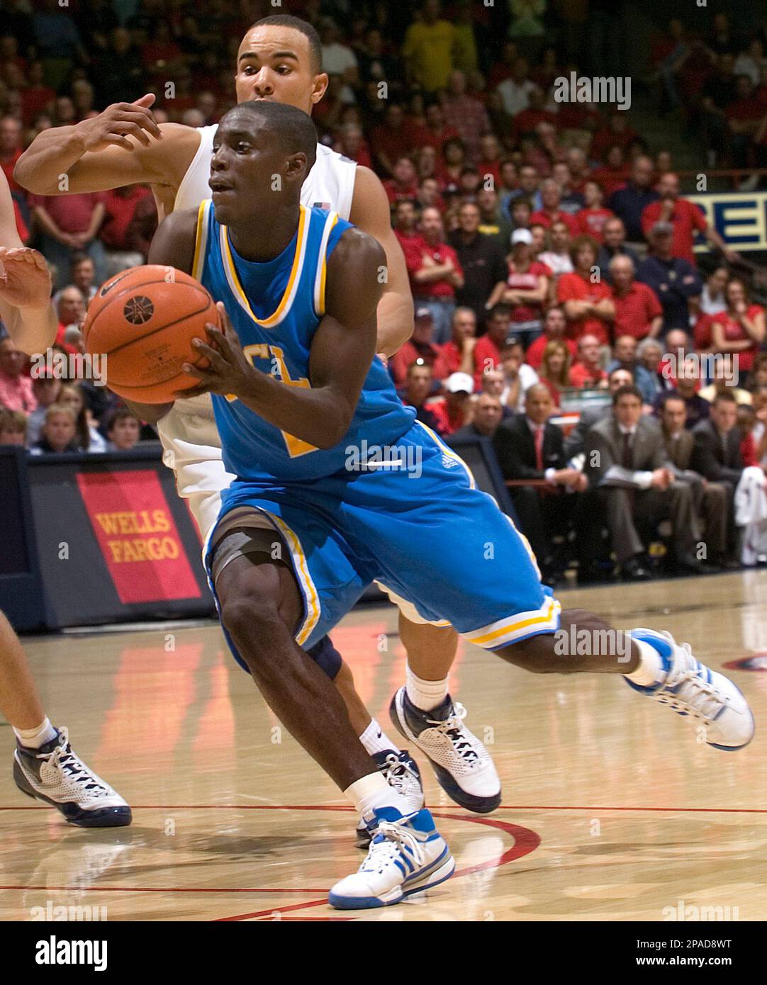 UCLA's Darren Collison in front, drives pass the defense of Arizona's ...