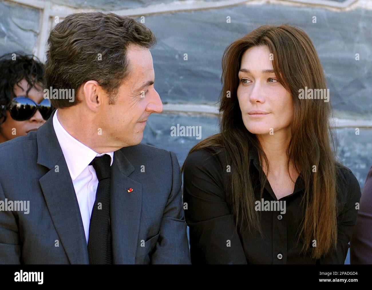 French President Nicolas Sarkozy and his wife Carla Bruni look on after ...