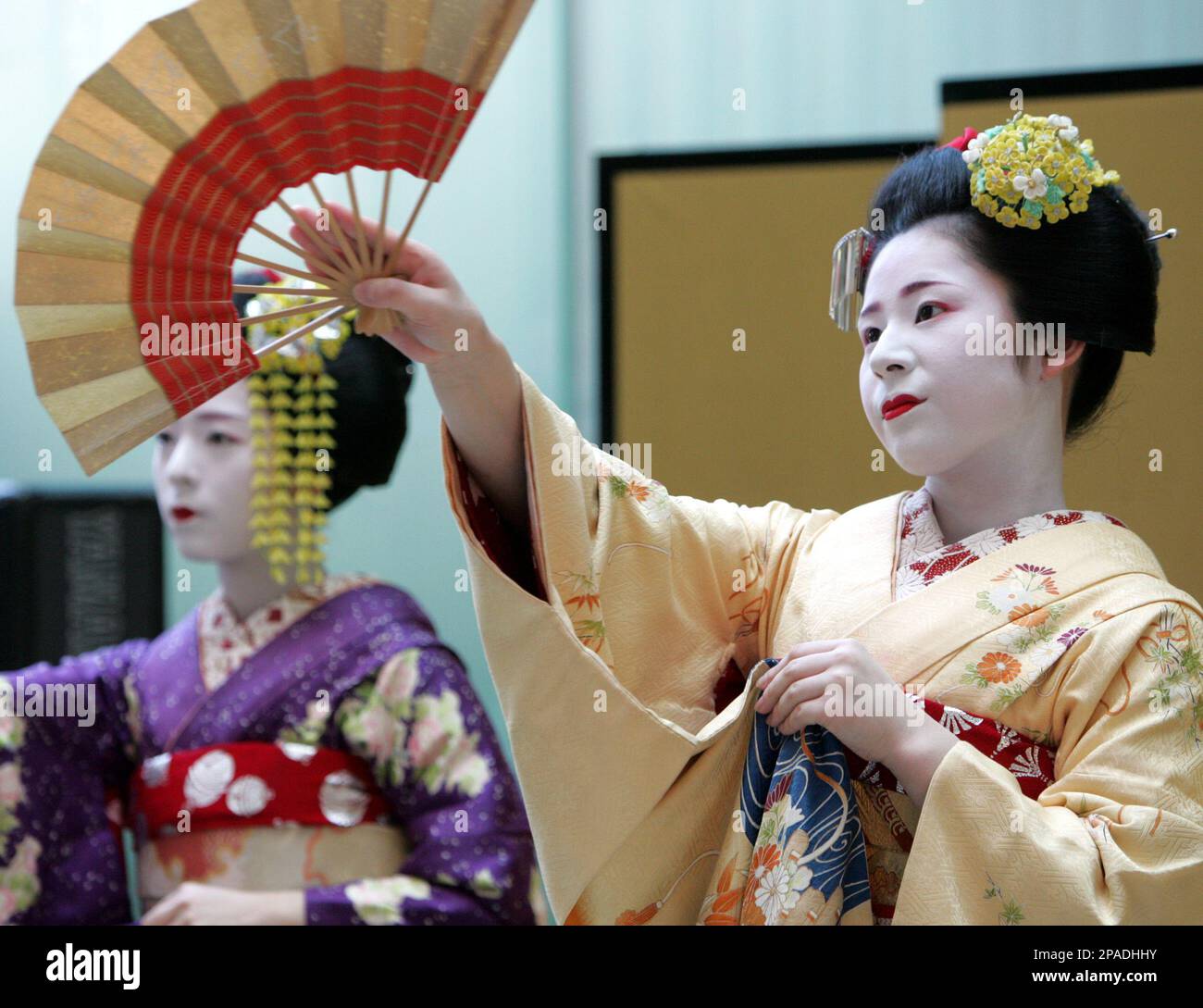 Seventeen-year-old maiko, or an apprentice geisha, Tomoyuki, right, and ...