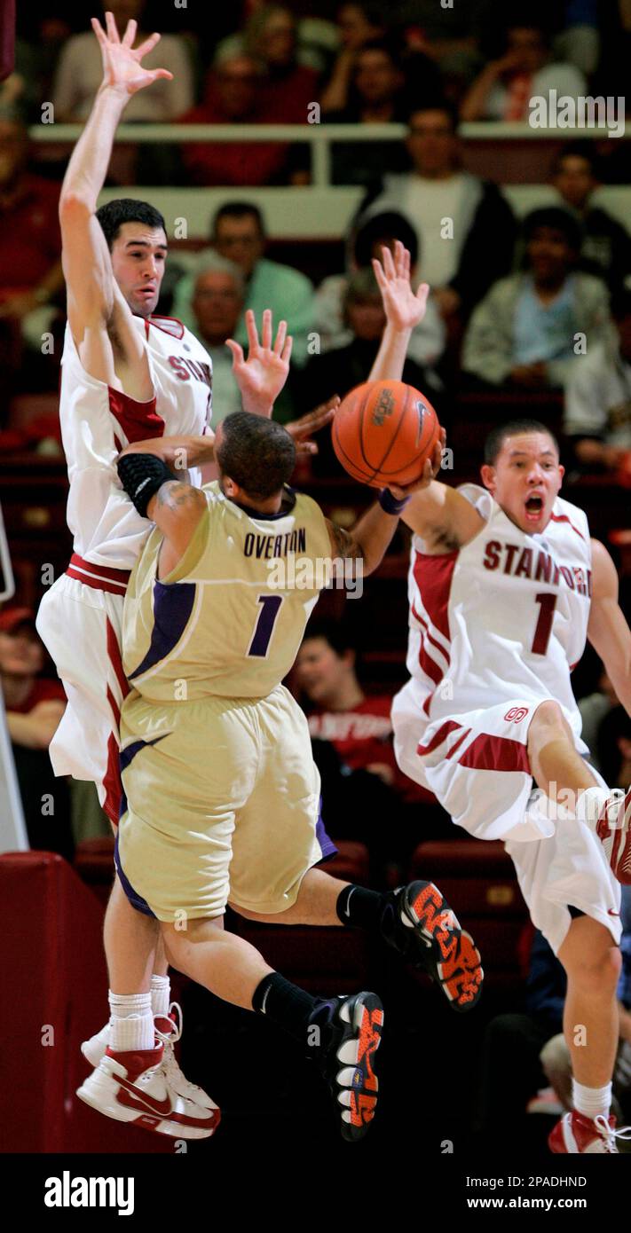 Washington's Venoy Overton, center, is defended by Stanford's Taj ...