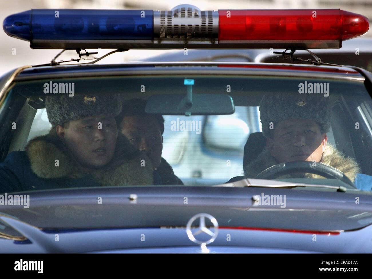 North Korean security officers sit inside their police car in Pyongyang ...