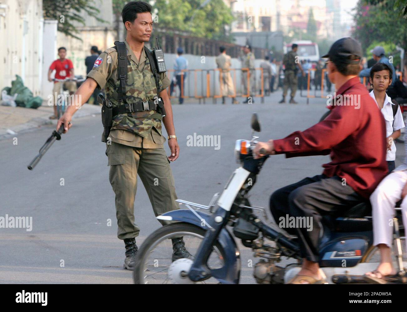 A Cambodian military police officer directs traffic at Tuol Sleng genocide museum in Phnom Penh ...