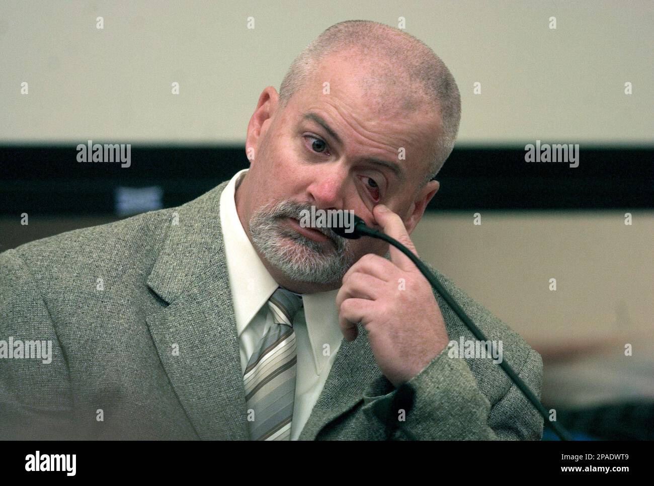 Former Weld County sheriff's investigator Ken Nelson rubs his eye as he ...