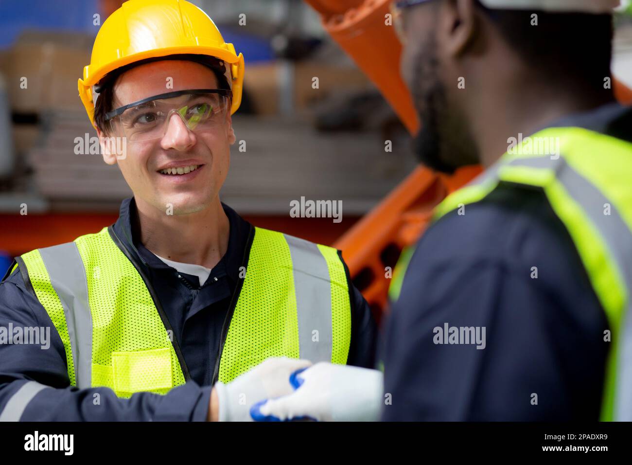 Two young engineer man handshake with partner for agreement while ...