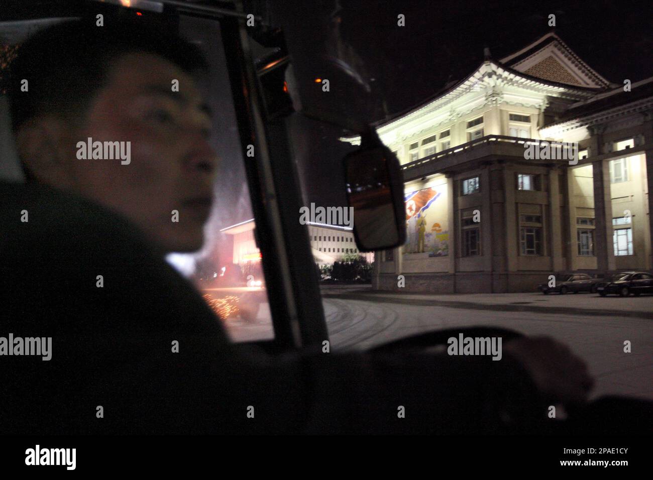 A North Korean bus driver, carrying press and visitors for the tour of ...