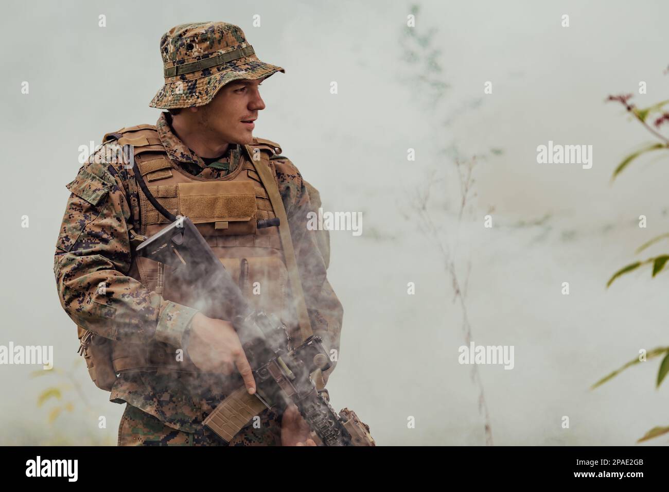 A soldier fights in a warforest area surrounded by fire Stock Photo - Alamy