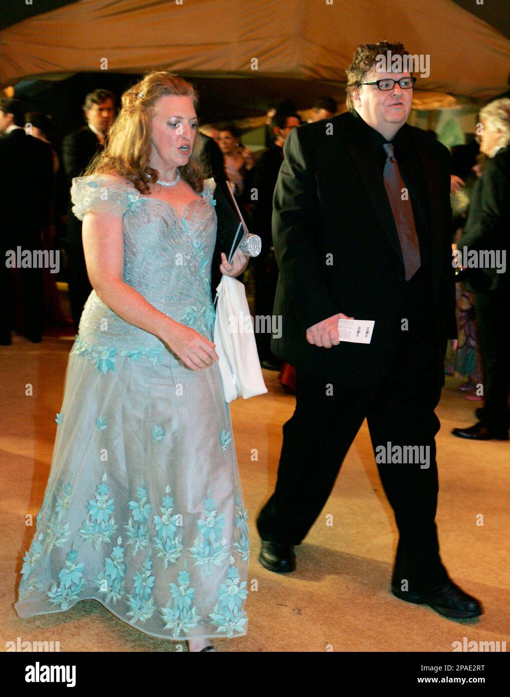 Michael Moore, right, and his wife, Kathleen Glynn, walk to the ...