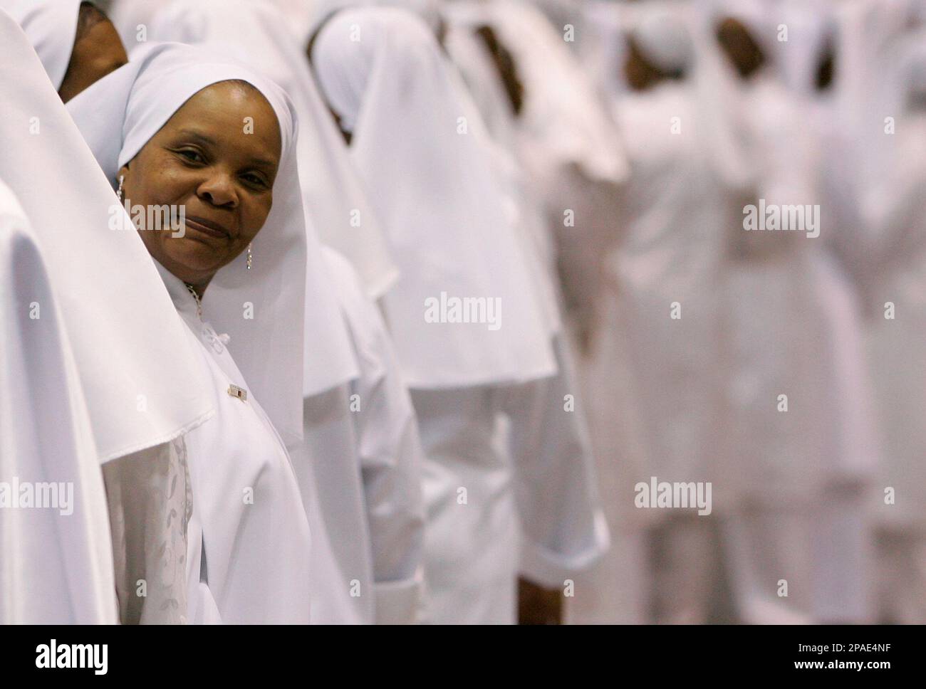 A Muslim Girl Trainee looks back towards the back of a line of women ...