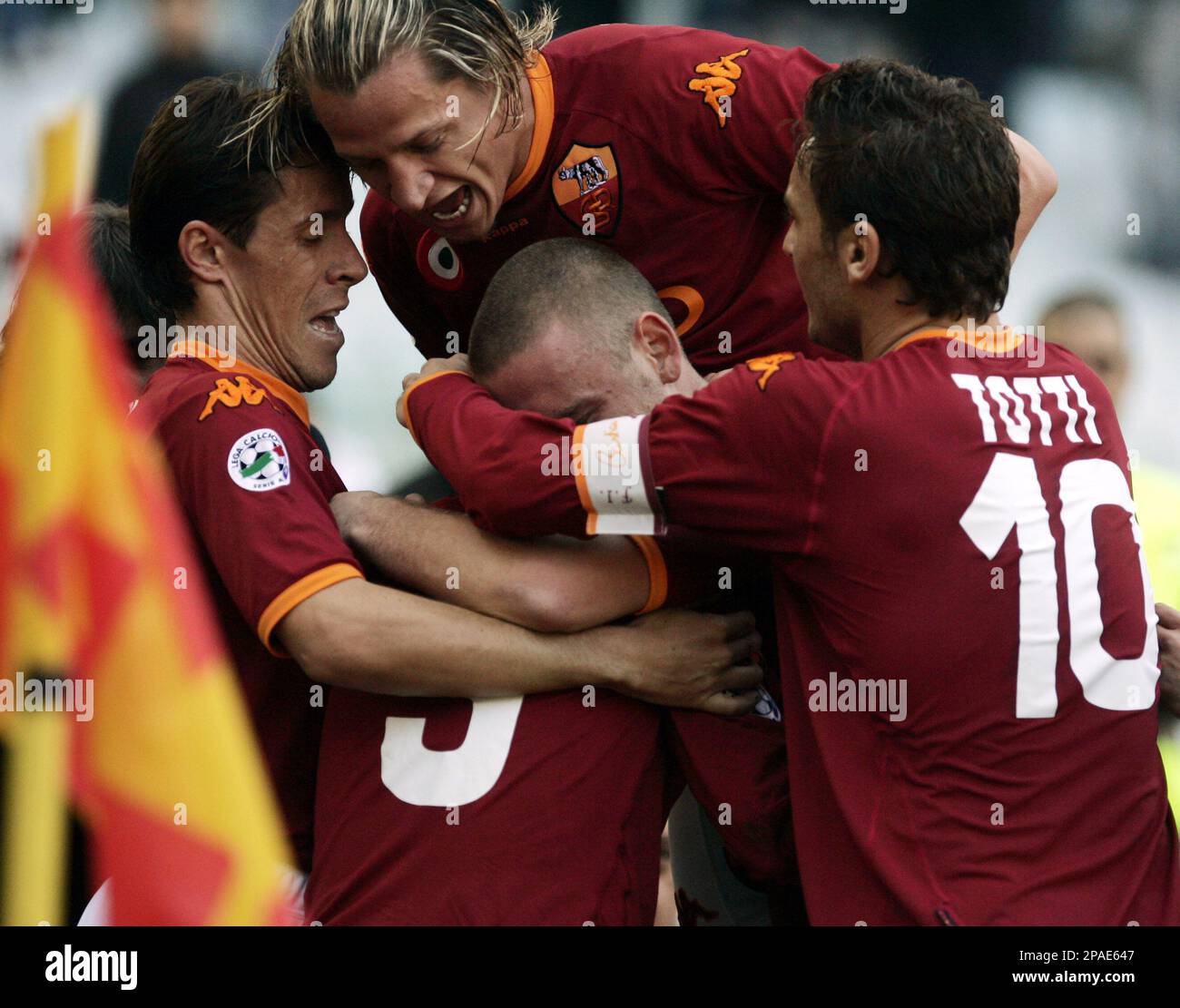 AS Roma's Cicinho, hidden at bottom center, is congratulated for ...