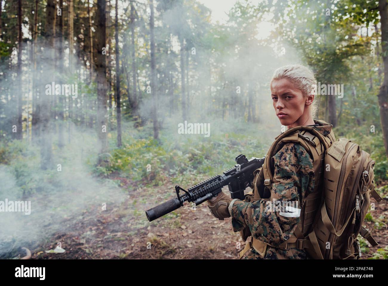 Woman soldier ready for battle wearing protective military gear and ...