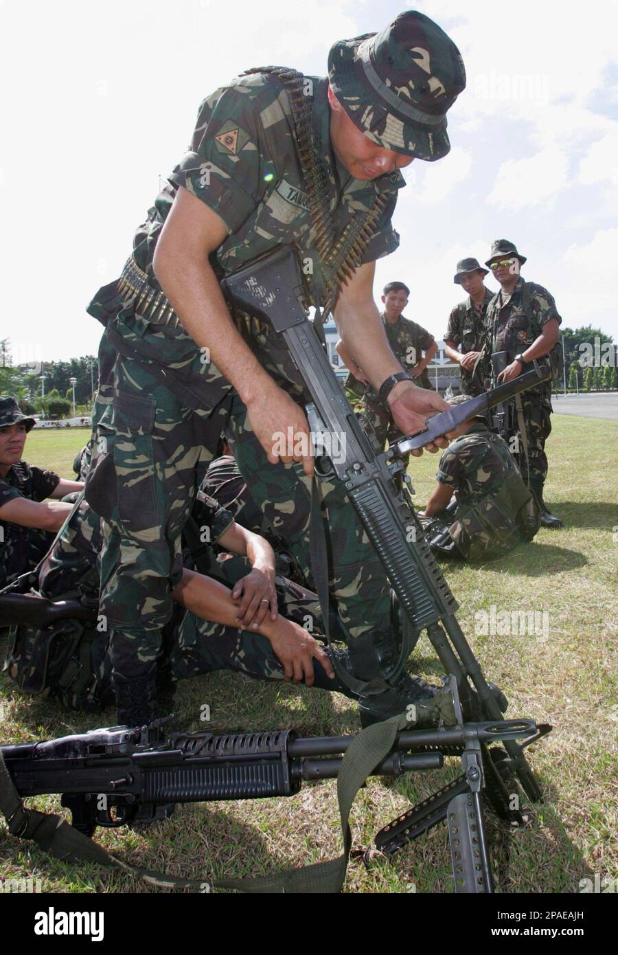 A Philippine Army soldier checks on his M-60 light machine-gun after ...