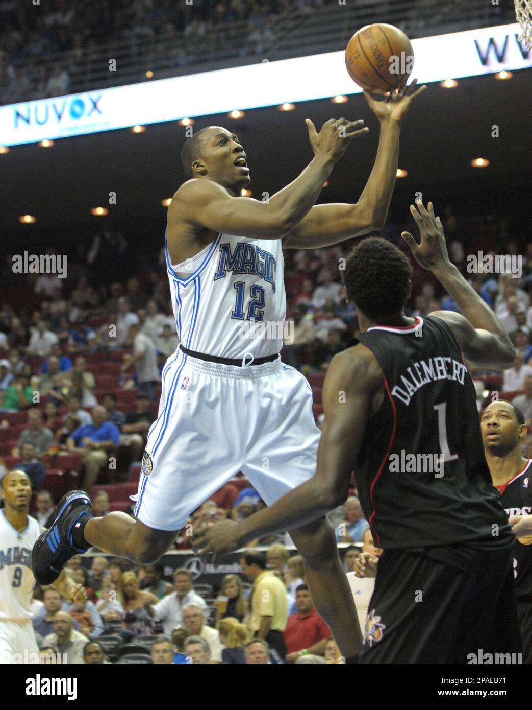 Orlando Magic center Dwight Howard, left, puts up a shot in front of ...