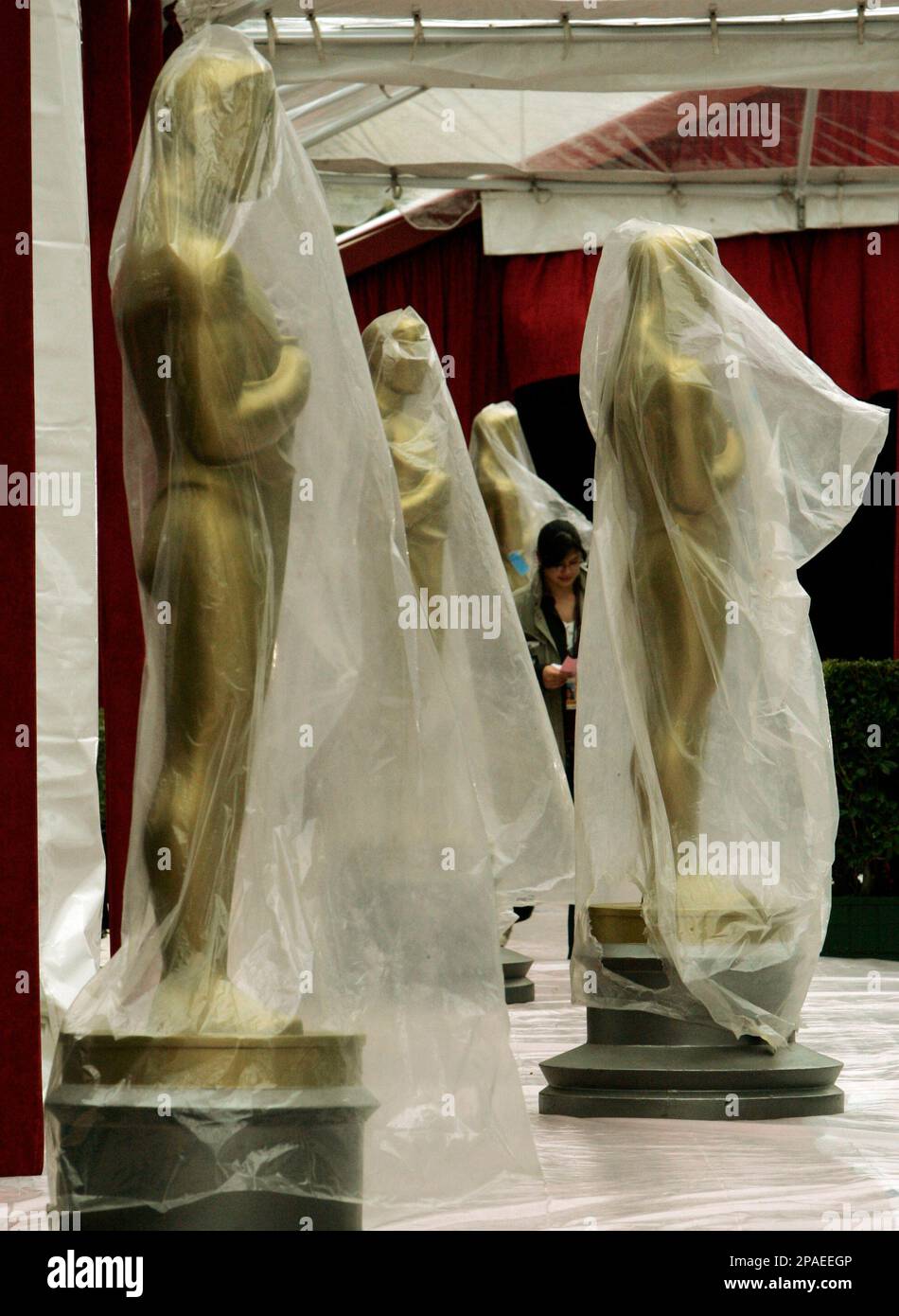 Oscar statues wrapped in plastic against predicted rain stand in the ...
