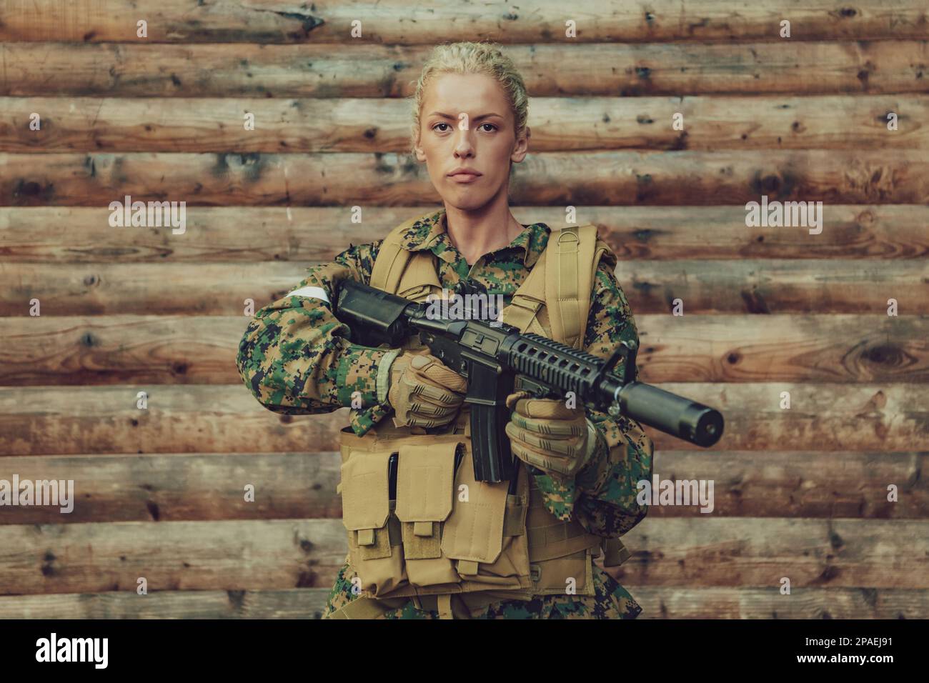 Woman soldier ready for battle wearing protective military gear and ...