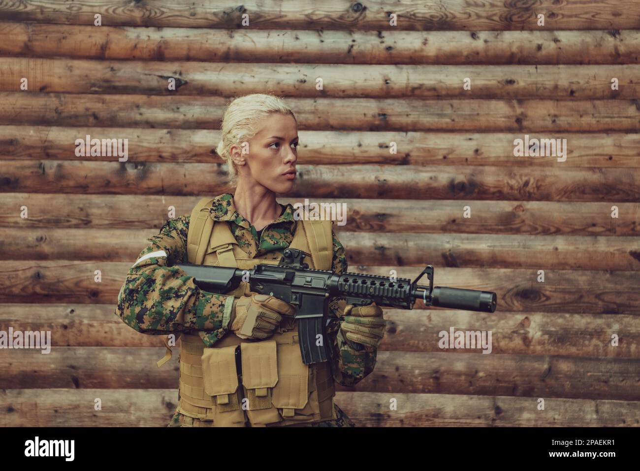 Woman soldier ready for battle wearing protective military gear and ...