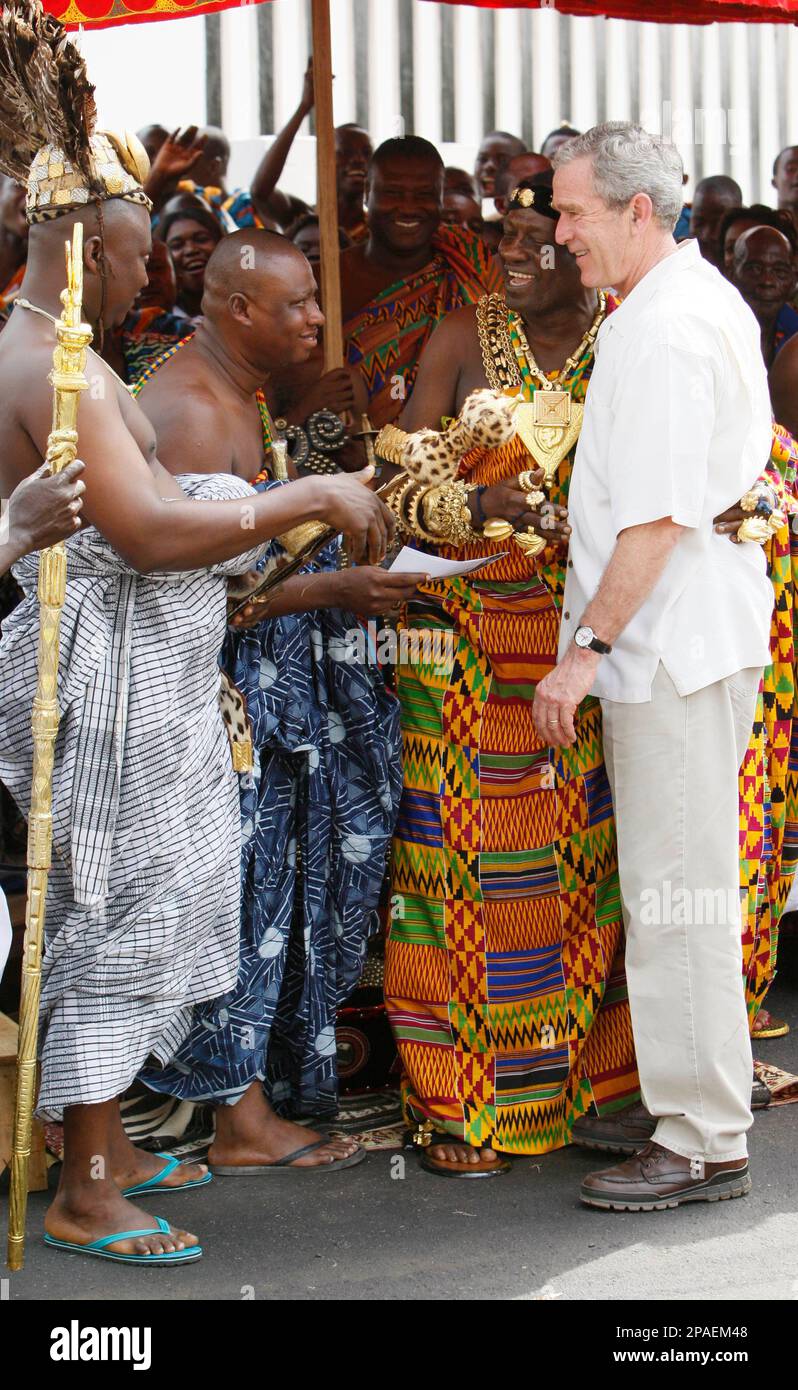 President Bush is embraced by Emmanuel Oti Boateng, a tribal leader ...