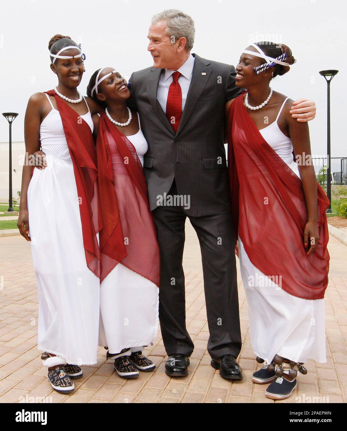President Bush poses with Rwandan dancers during a dedication ceremony ...