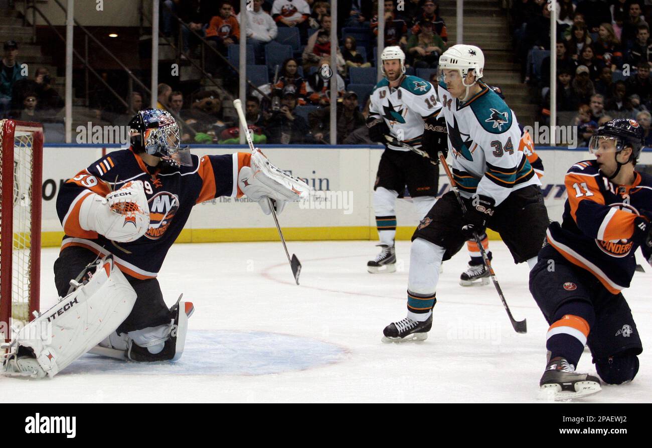 New York Islanders goalie Rick DiPietro, left, blocks a shot as Andy ...