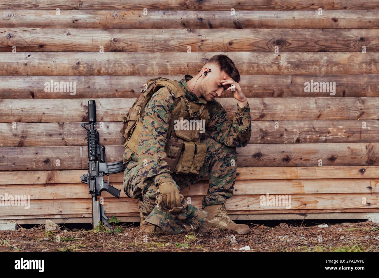 Upset soldier has psychological problems holding his head Stock Photo ...