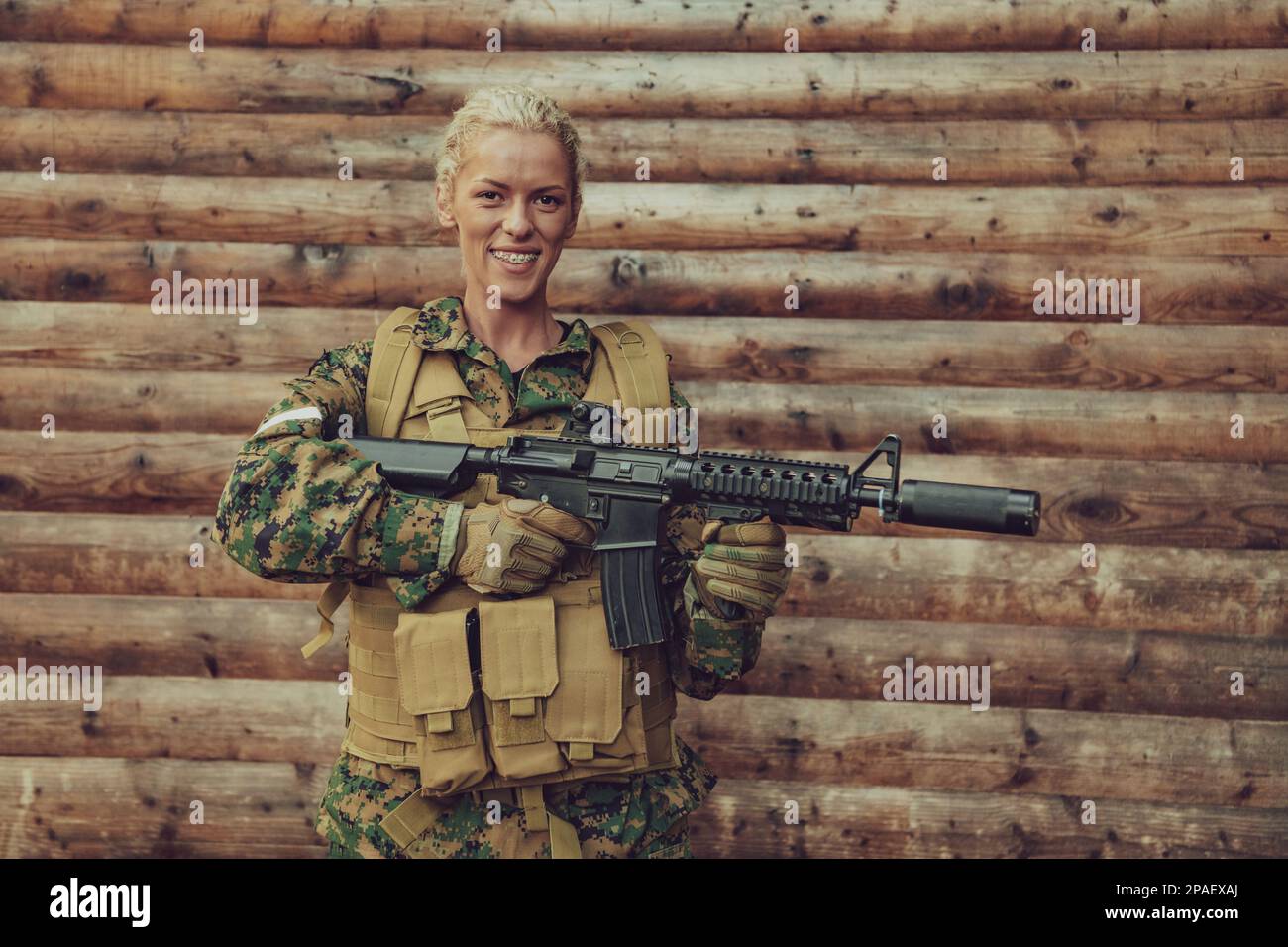 Woman soldier ready for battle wearing protective military gear and ...