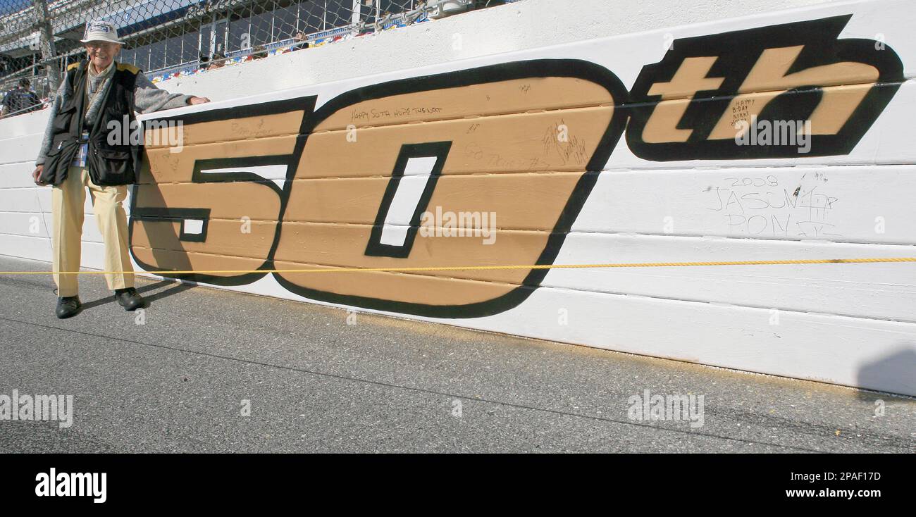 Photographer T. Taylor Warren poses by the 50th logo on the wall before ...