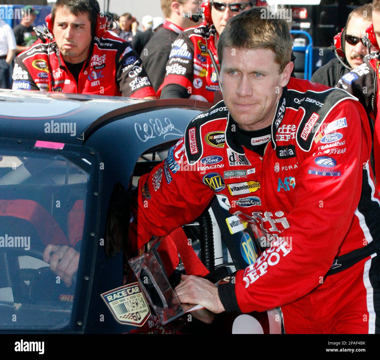 NASCAR driver Carl Edwards pushes his car through the garage during ...