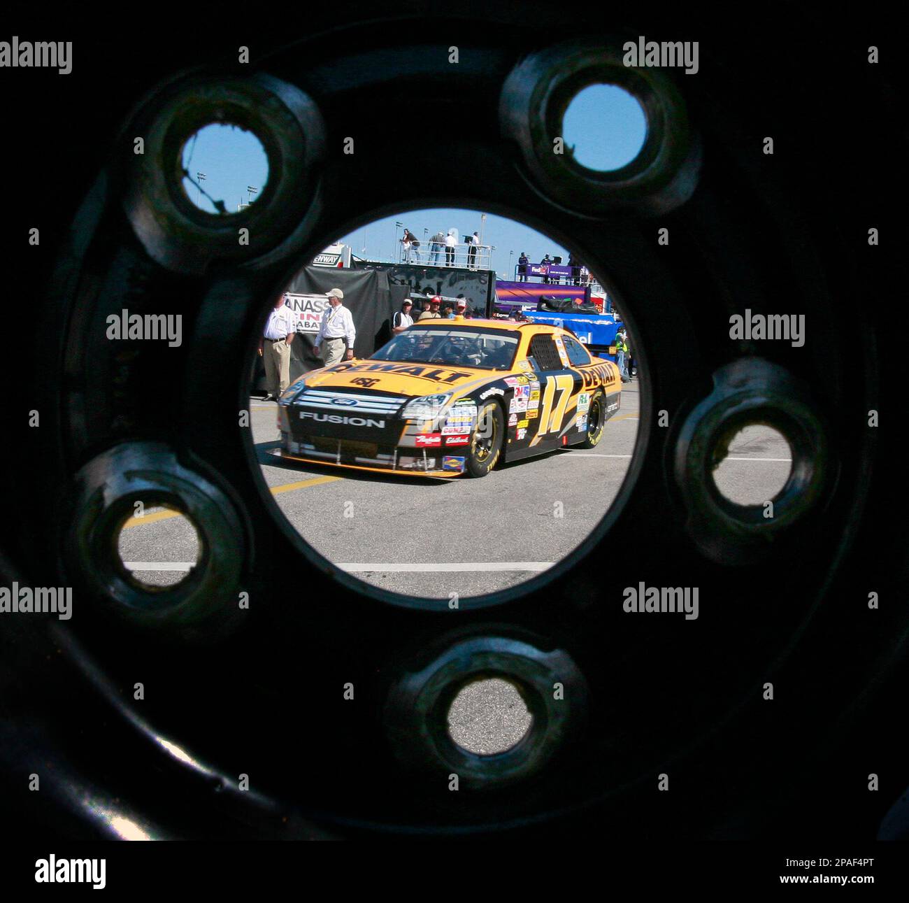 Matt Kenseth is shown through the wheel of a race car during practice ...