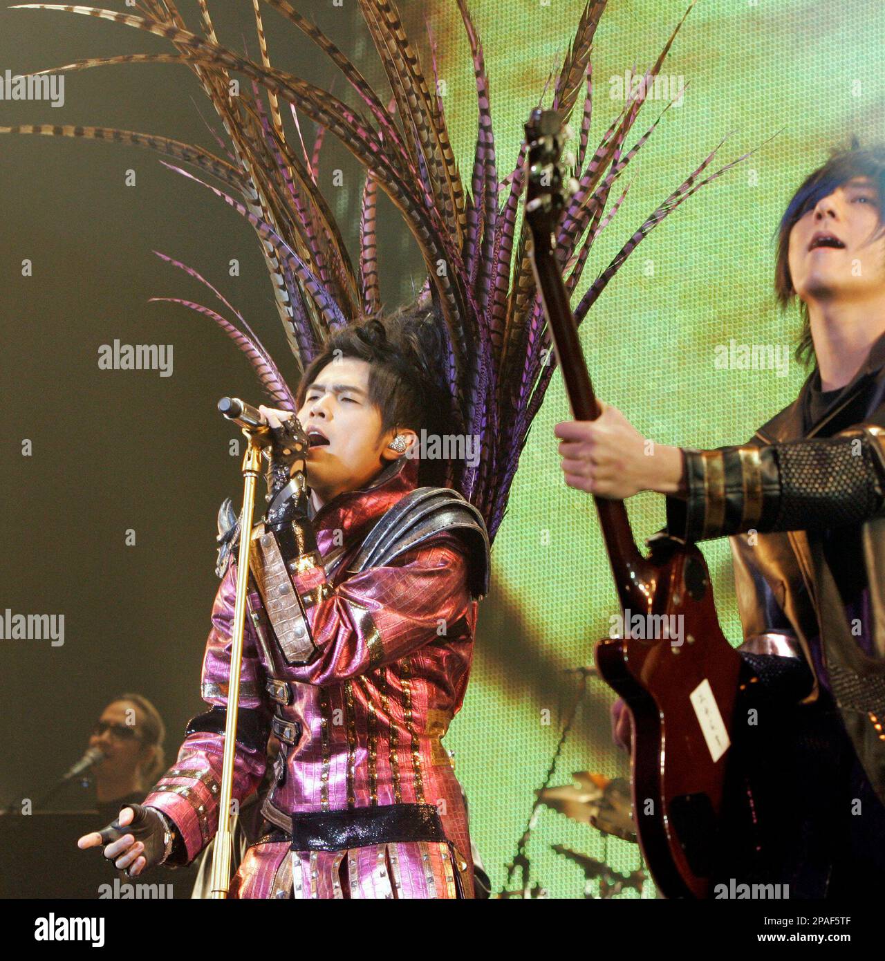 Taiwanese pop star Jay Chou, left, performs on stage during his world ...