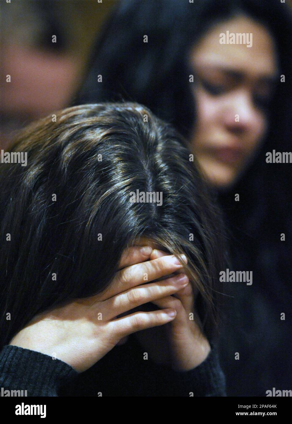 Northern Illinois University student Audrey Holmer foreground, prays ...