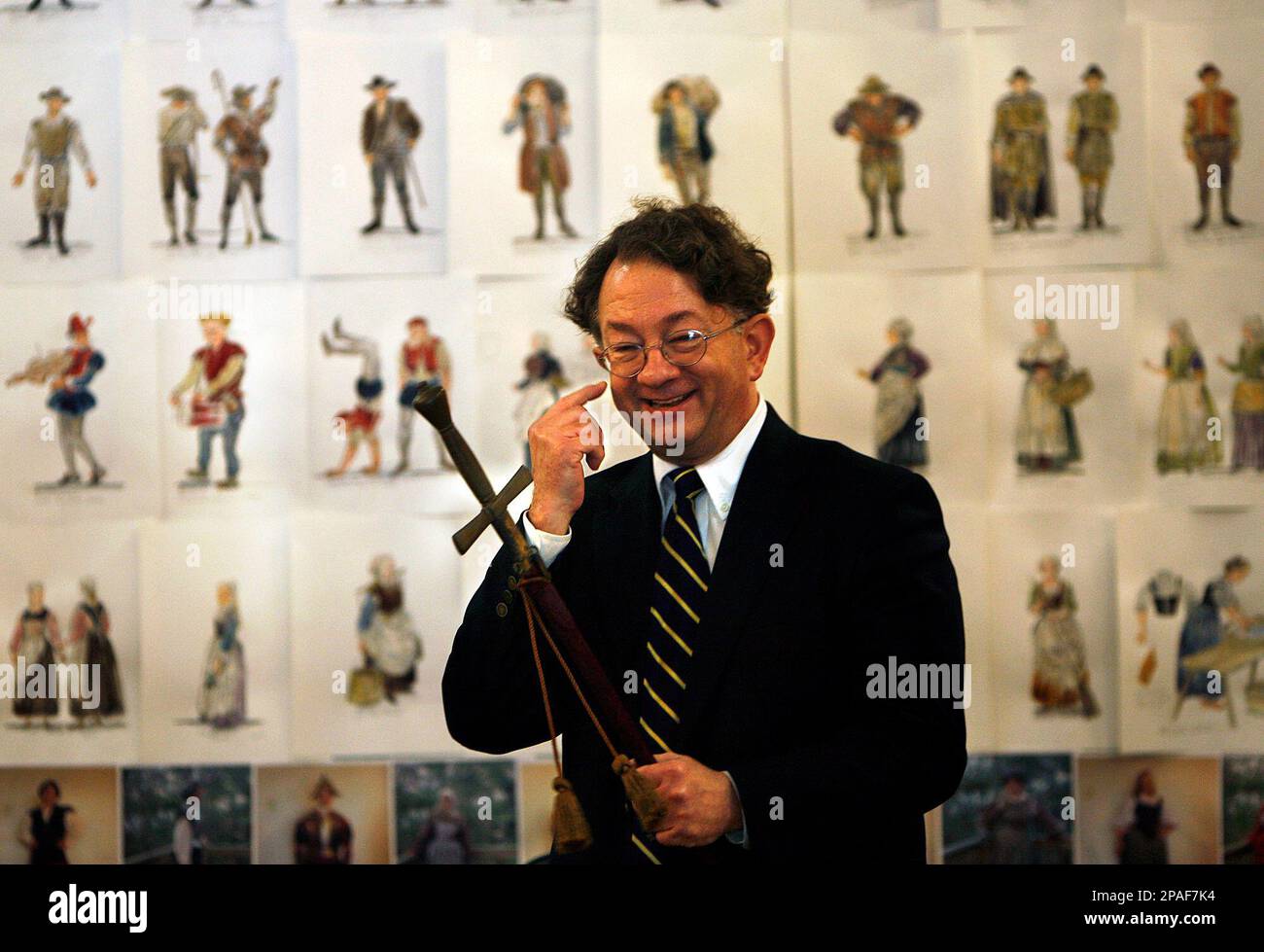 Tony Award-winning costume designer William Ivey Long looks at a sword ...