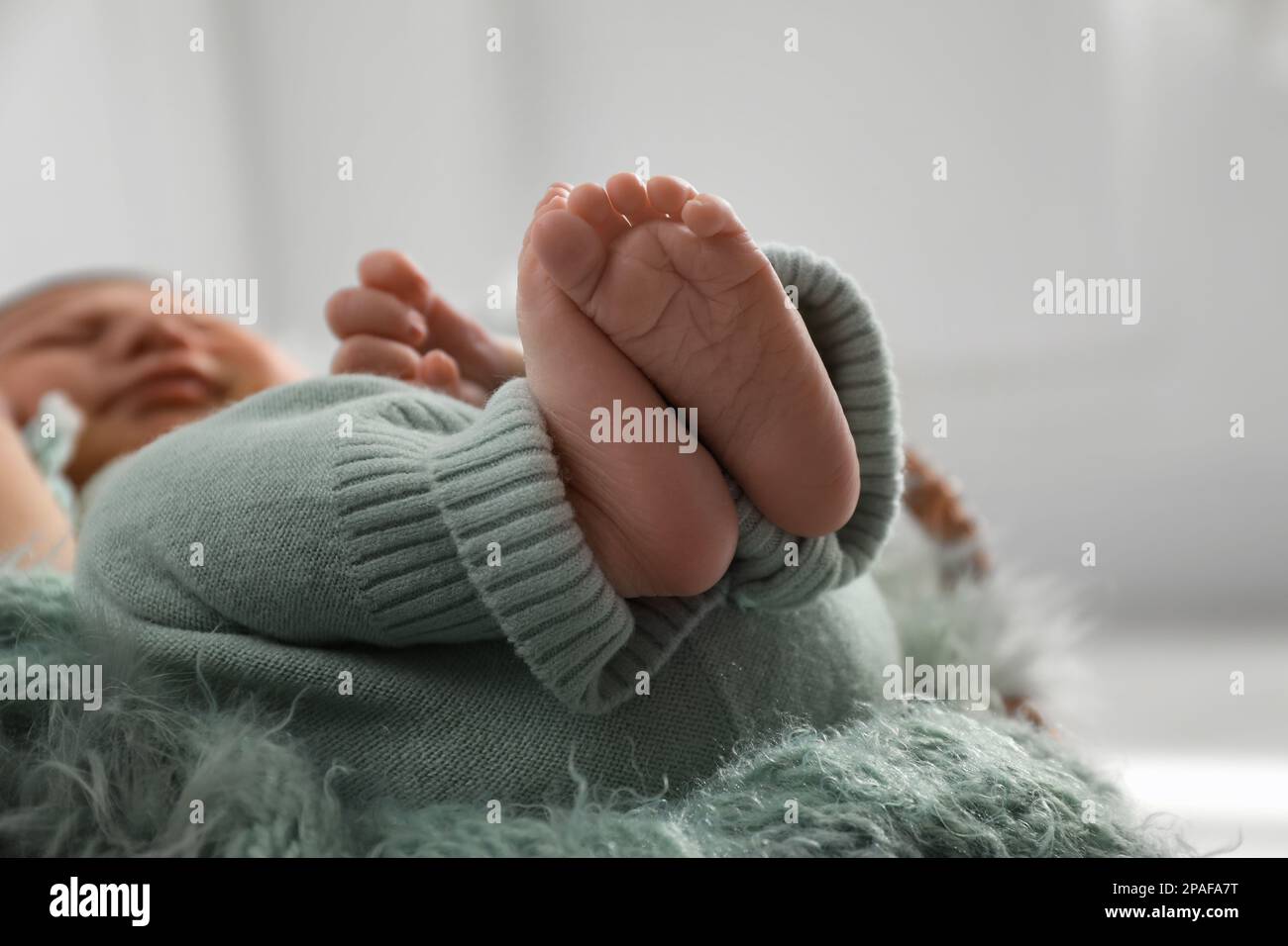 Cute newborn baby sleeping on fuzzy blanket, focus on legs Stock Photo ...