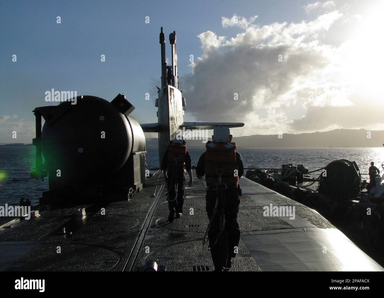 Crew members are silhouetted against the sun on the USS Ohio, U.S. Navy ...