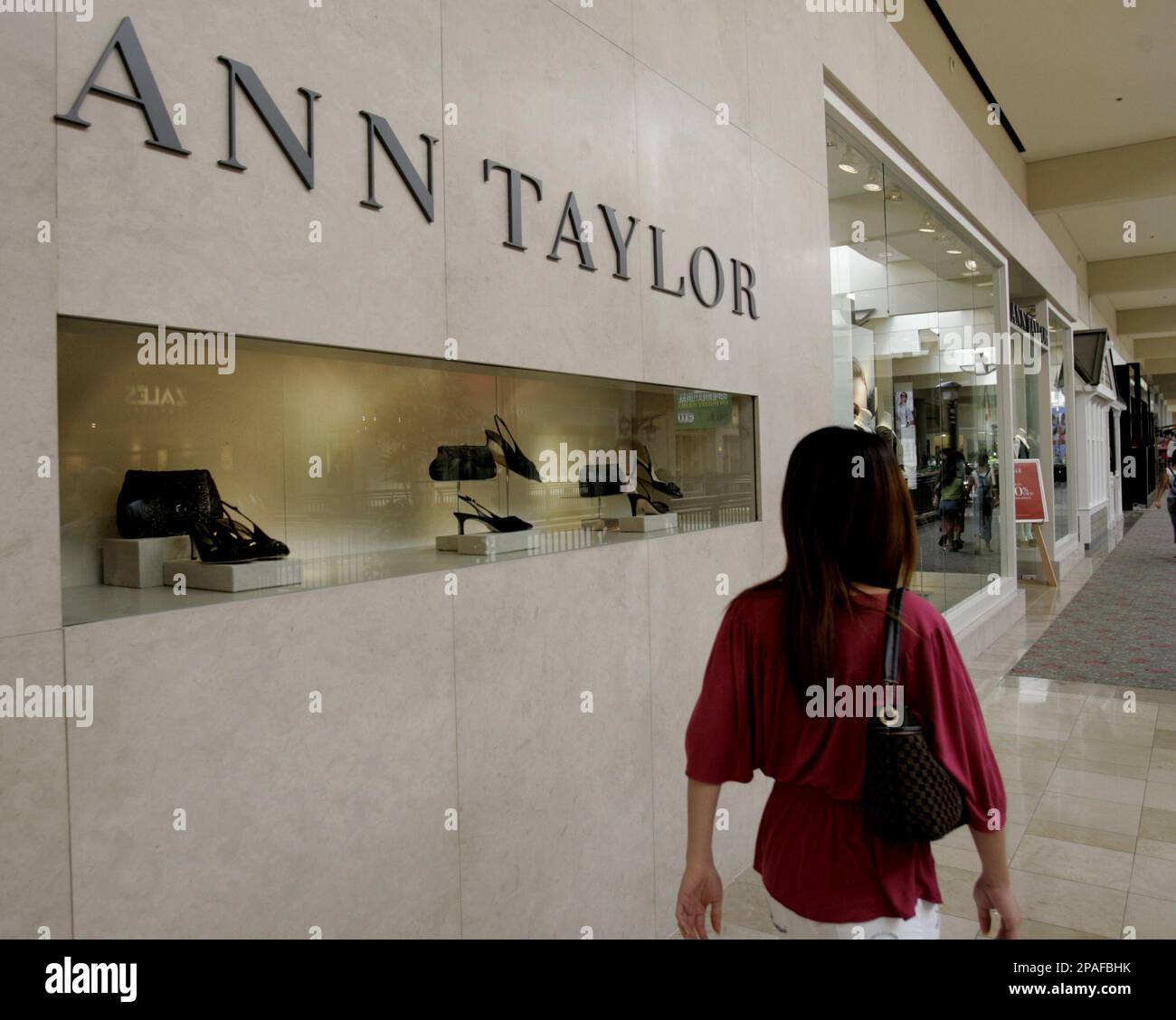 ** FILE ** A shopper walks by an Ann Taylor store in San Jose, Calif ...