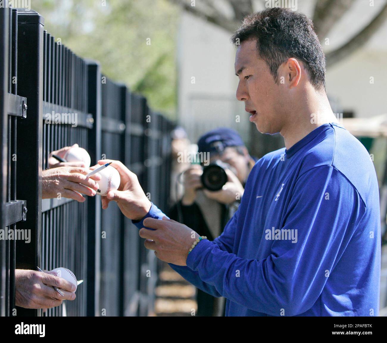 LA Dodgers pitcher Hiroki Kuroda of Japan autographs balls as the ...